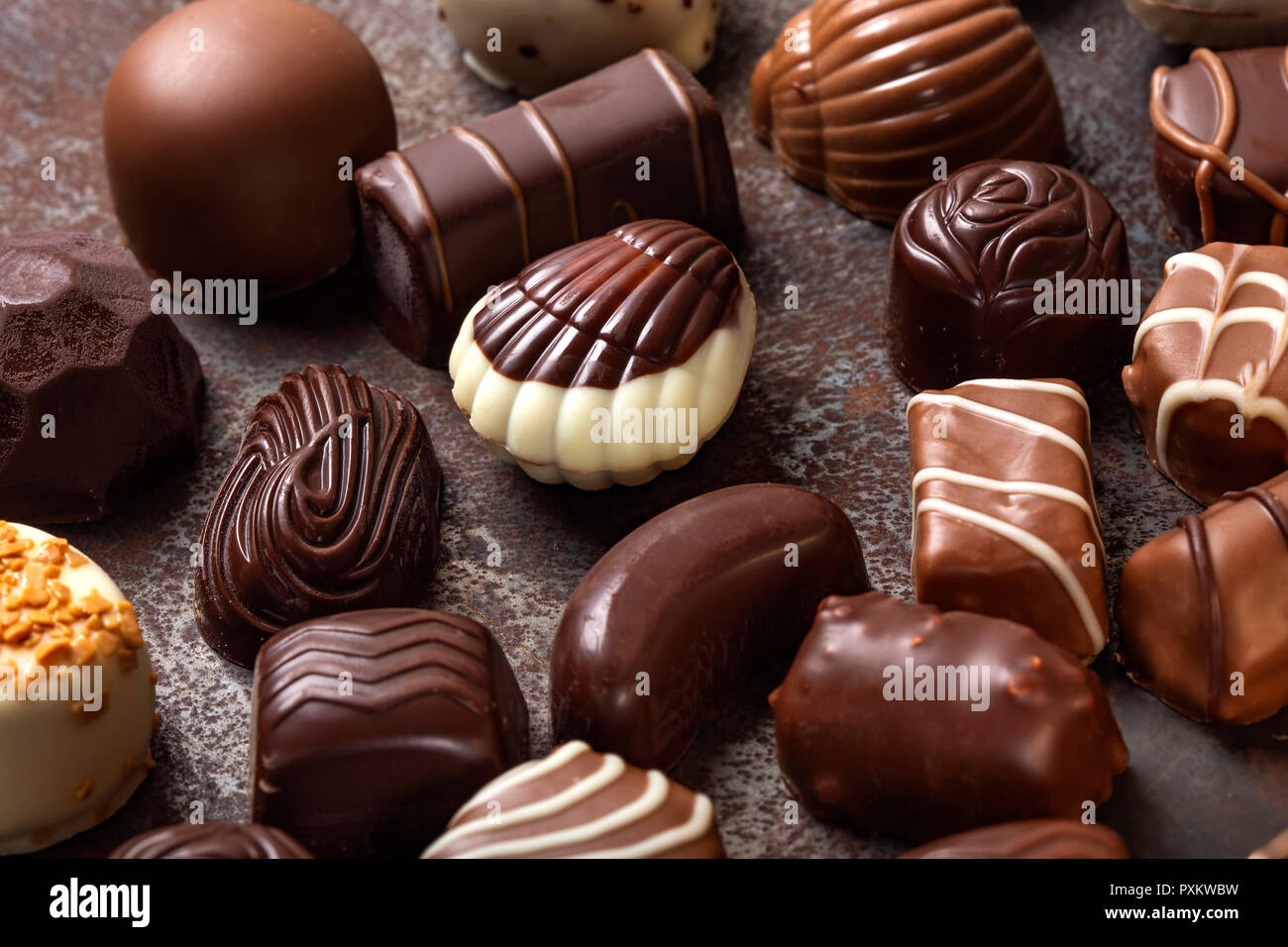 Different type of chocolate candies on a dark background - close up ...