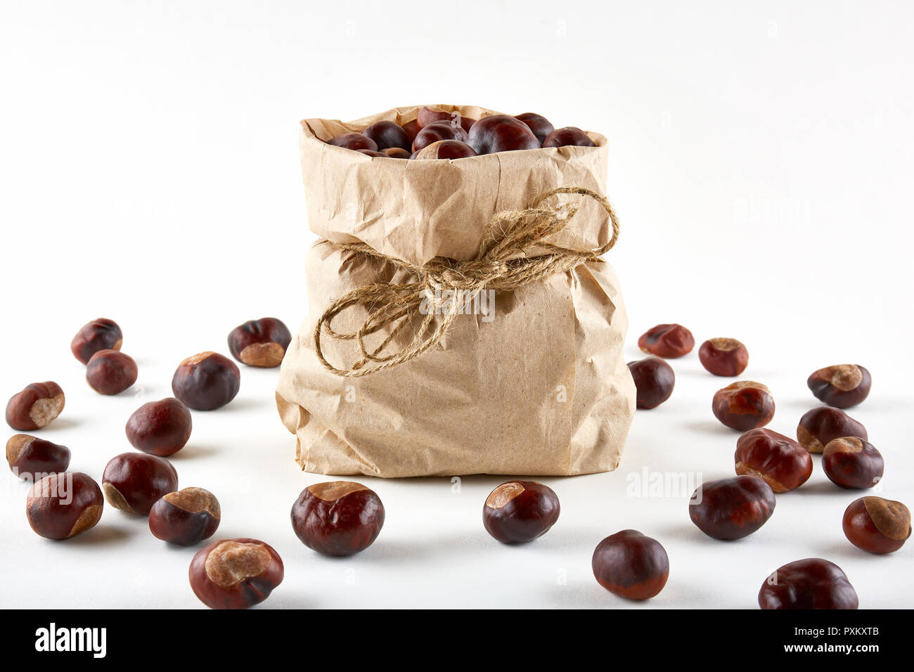 Chestnuts in paper bag on white background Stock Photo - Alamy