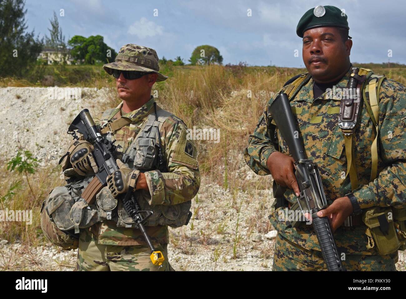 Florida National Guard Sgt. Randall Green stands guard with a member of ...