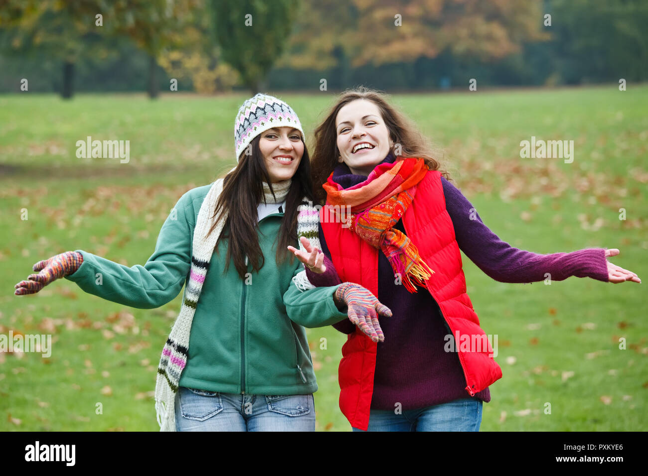 Two pretty girls having fun in autumn park Stock Photo - Alamy