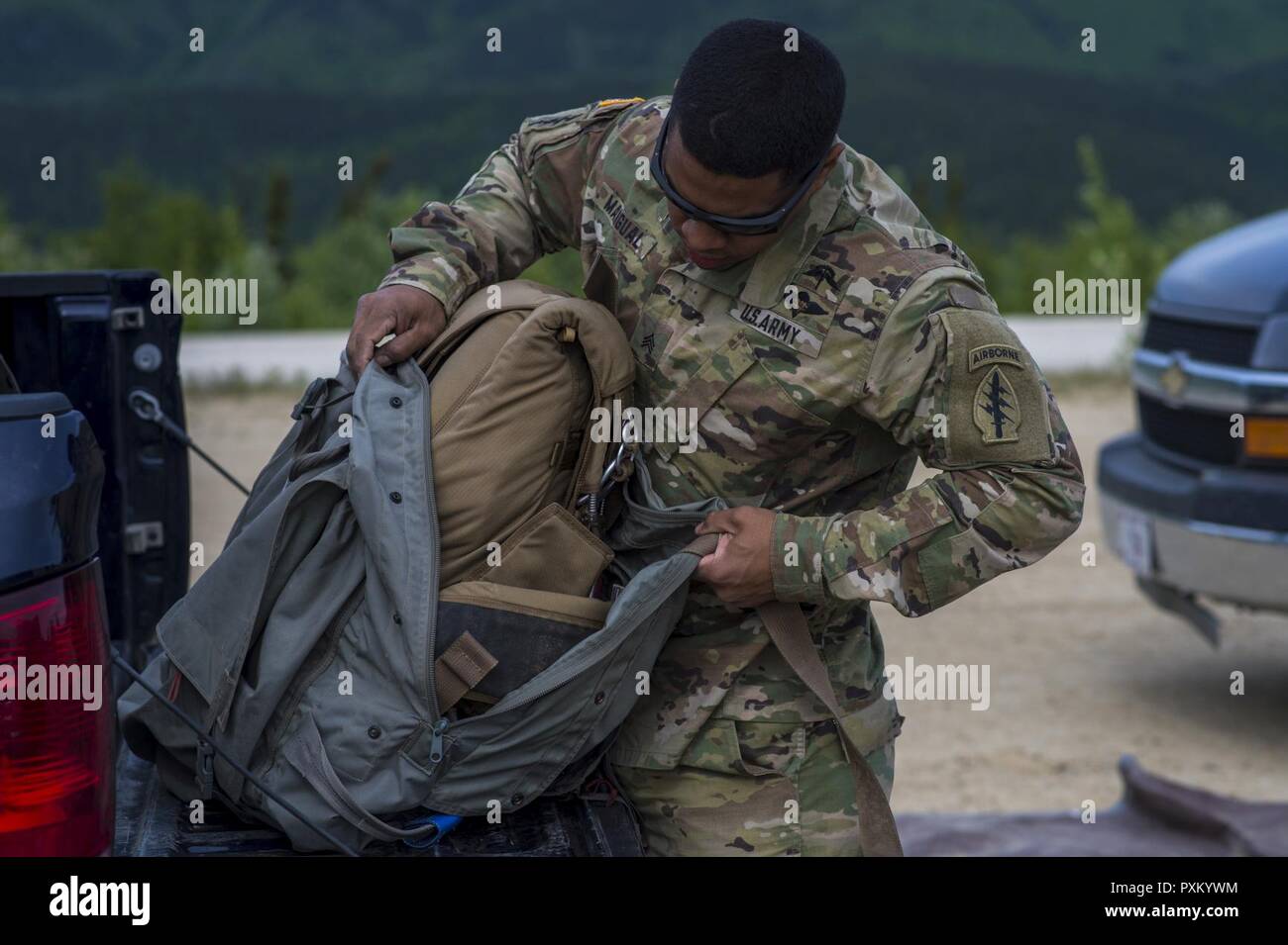 U.S. Army Sgt. Nelson Mangual, a parachute rigger assigned to the 3rd ...