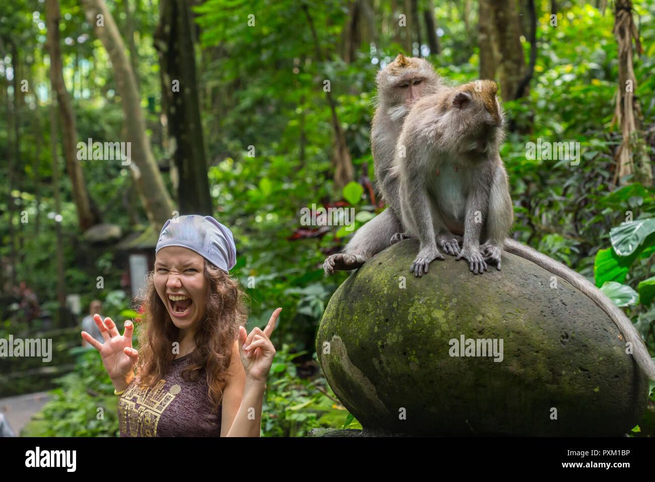 CLOSE UP: Young Caucasian woman posing for a photo with cute monkey on ...