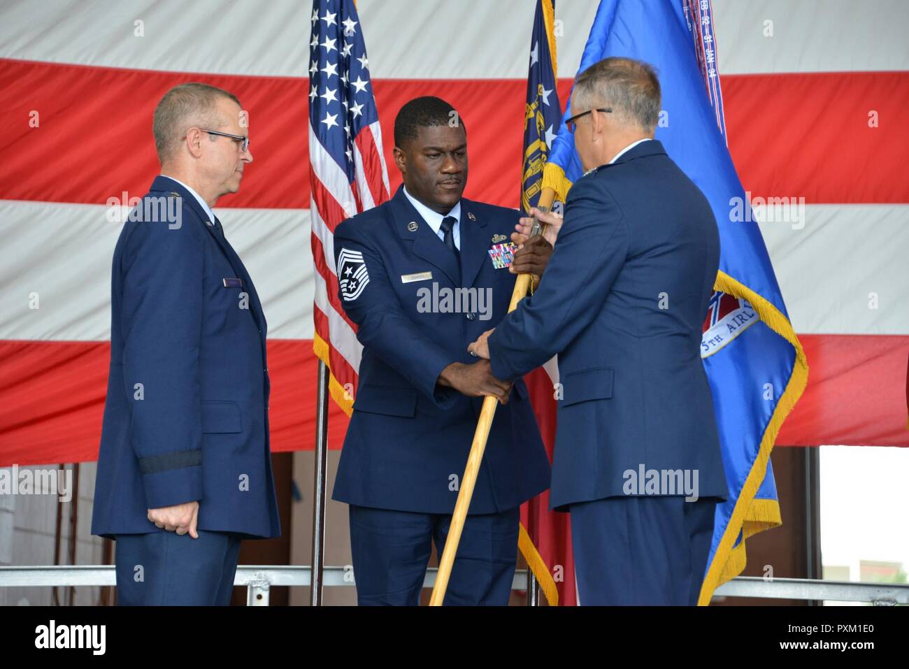 Outgoing Commander Col. Rainer Gomez, passes the Wing Flag to Maj. Gen ...