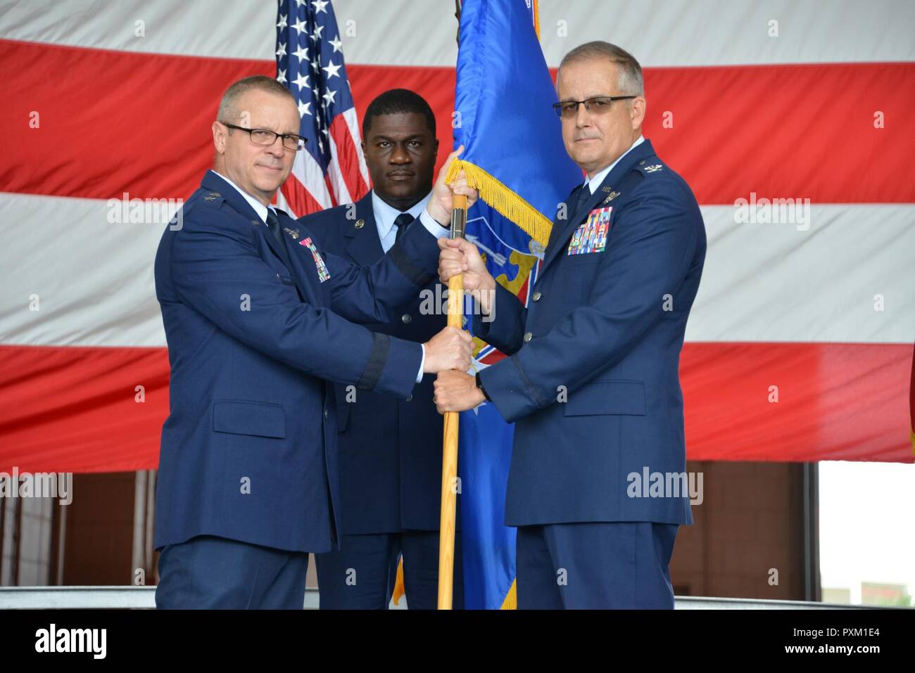 Outgoing Commander Col. Rainer Gomez, passes the Wing Flag to Maj. Gen ...