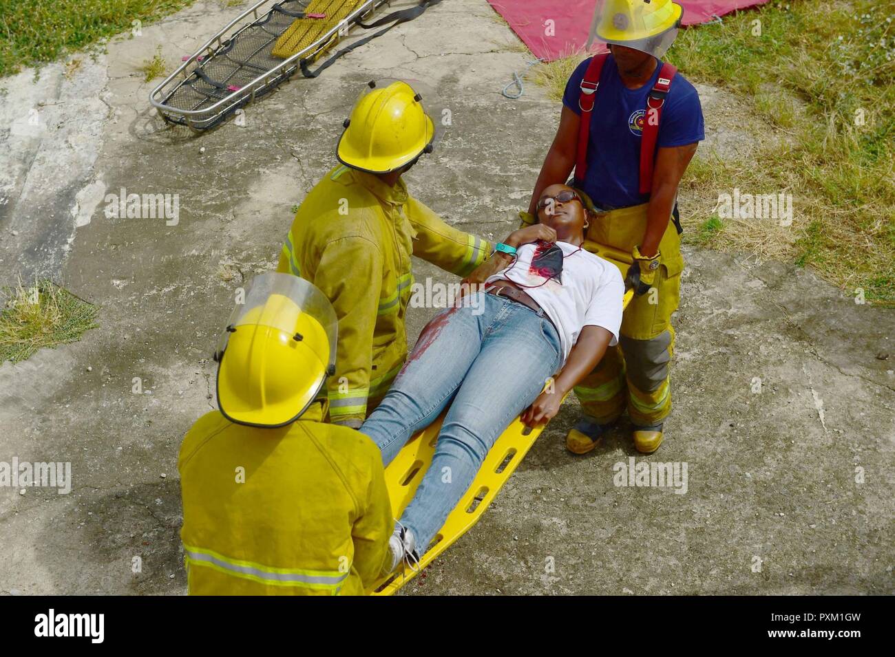 Fire officers from the Bridgetown Fire Department assess and assist a ...