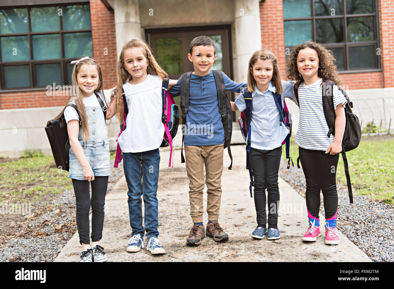 Group of students outside at school standing together Stock Photo - Alamy