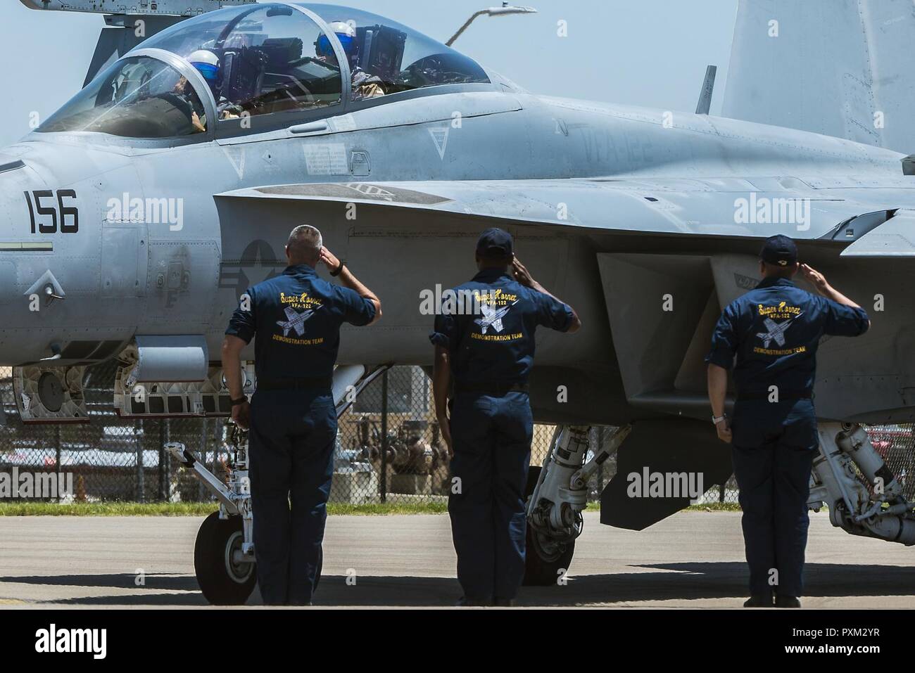 Members of the U.S. Navy Tactical Demonstration Team salute the pilots ...