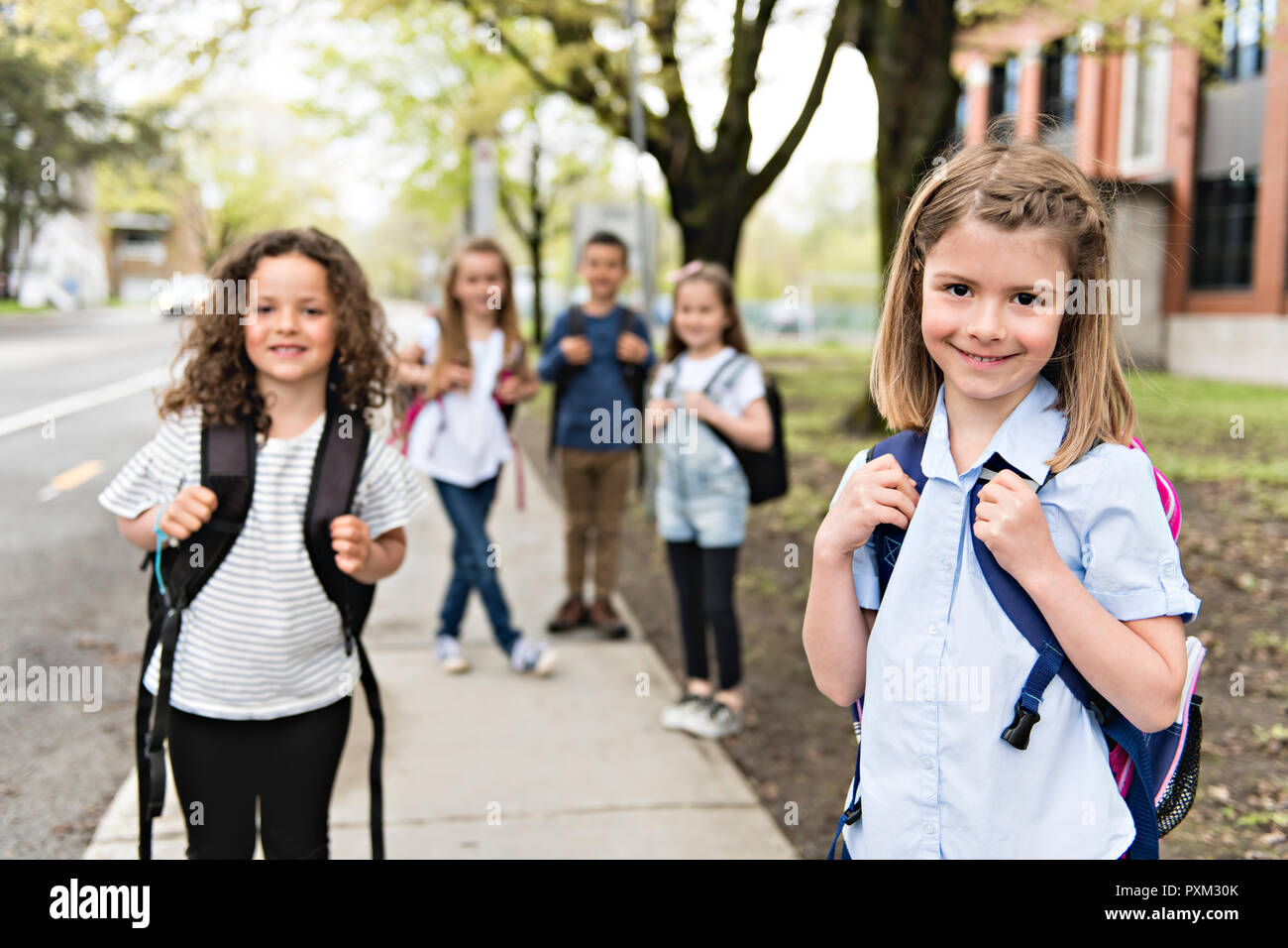 Group of students outside at school standing together Stock Photo - Alamy