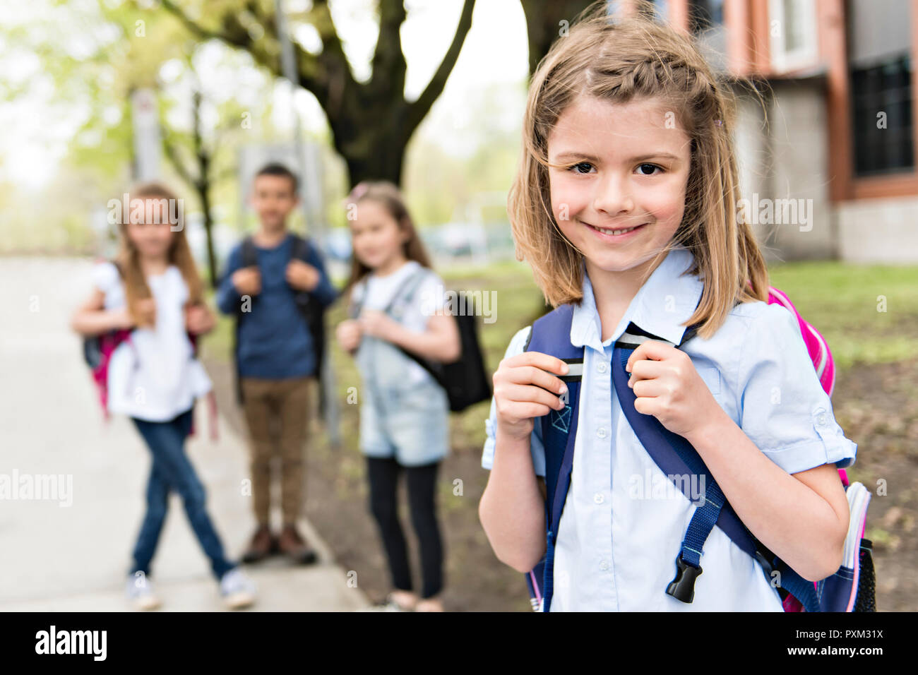 Group of students outside at school standing together Stock Photo - Alamy