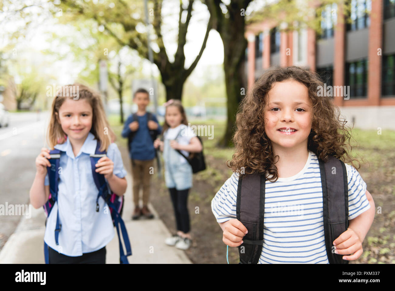 Group of students outside at school standing together Stock Photo - Alamy