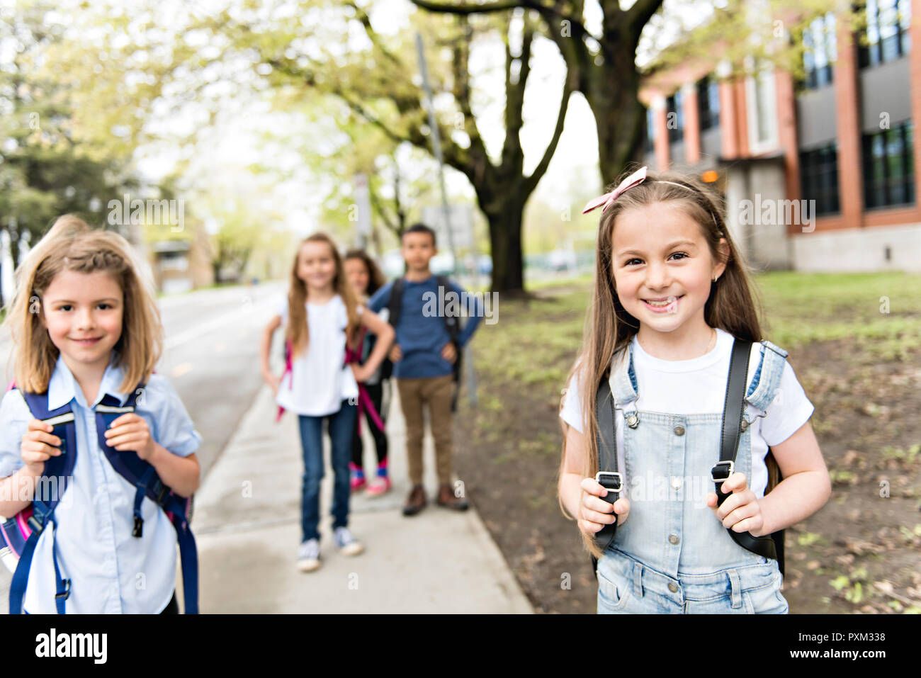 Group of students outside at school standing together Stock Photo - Alamy