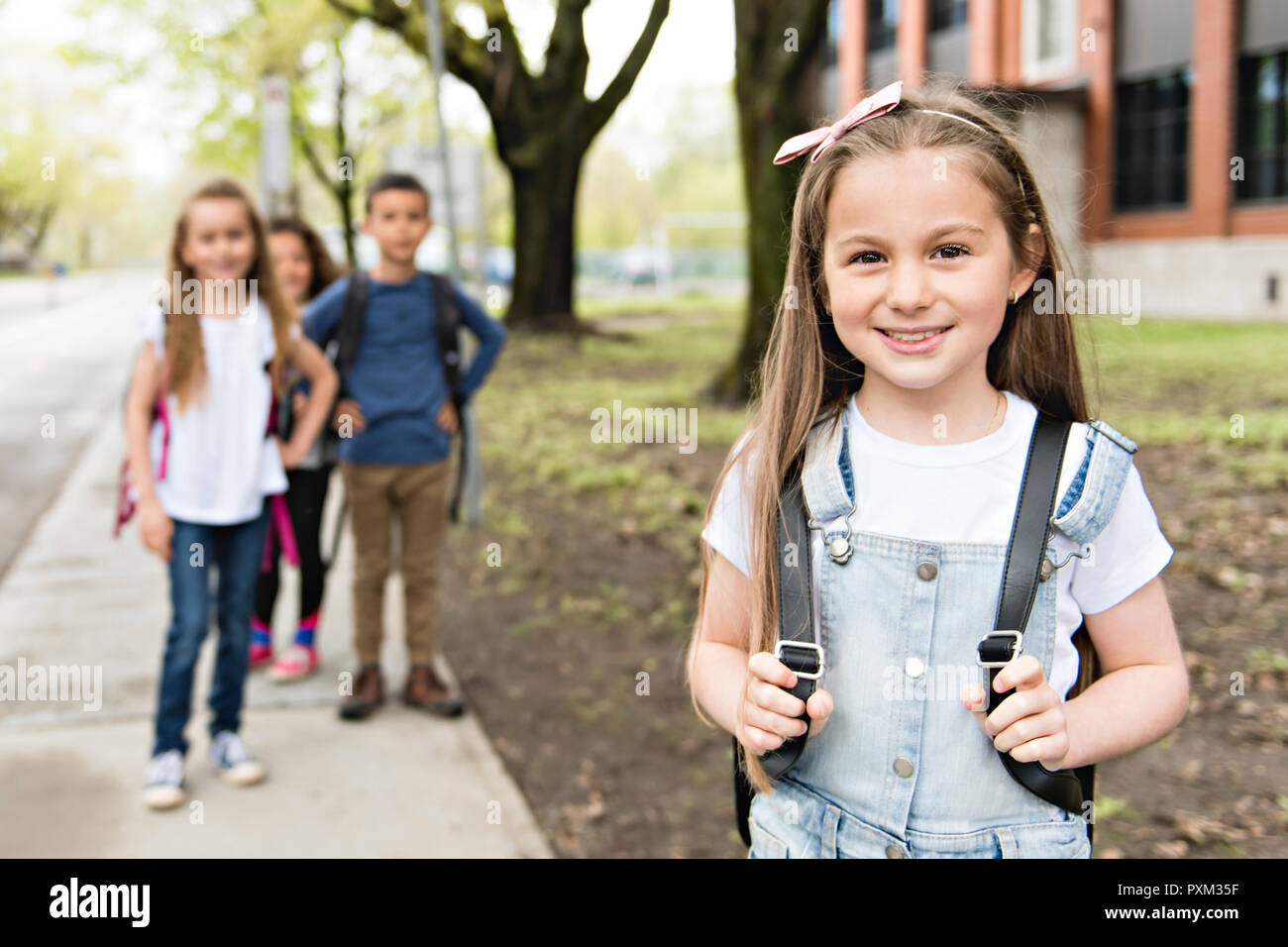 Group of students outside at school standing together Stock Photo - Alamy