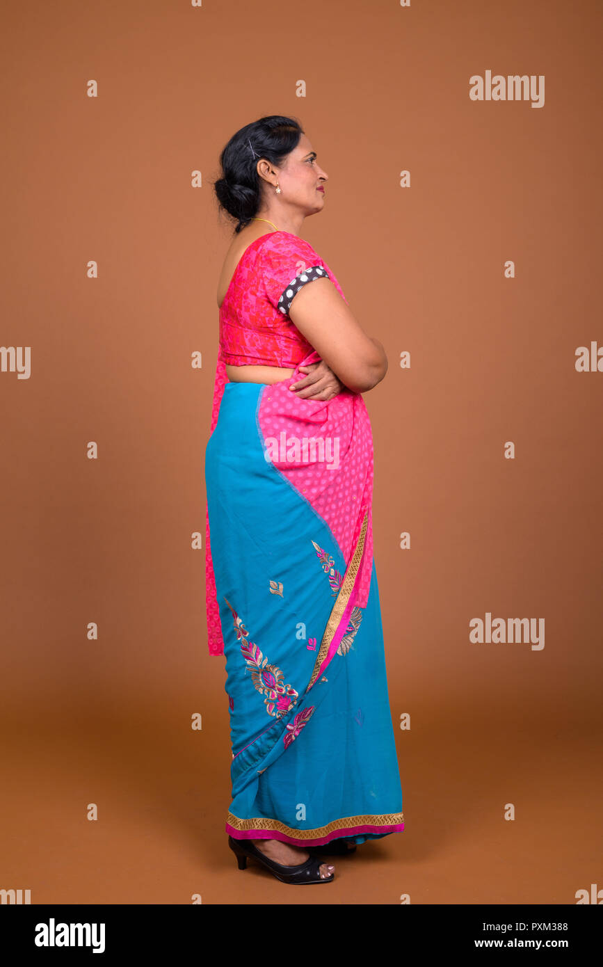 Full length profile view of Indian woman wearing traditional clothes ...