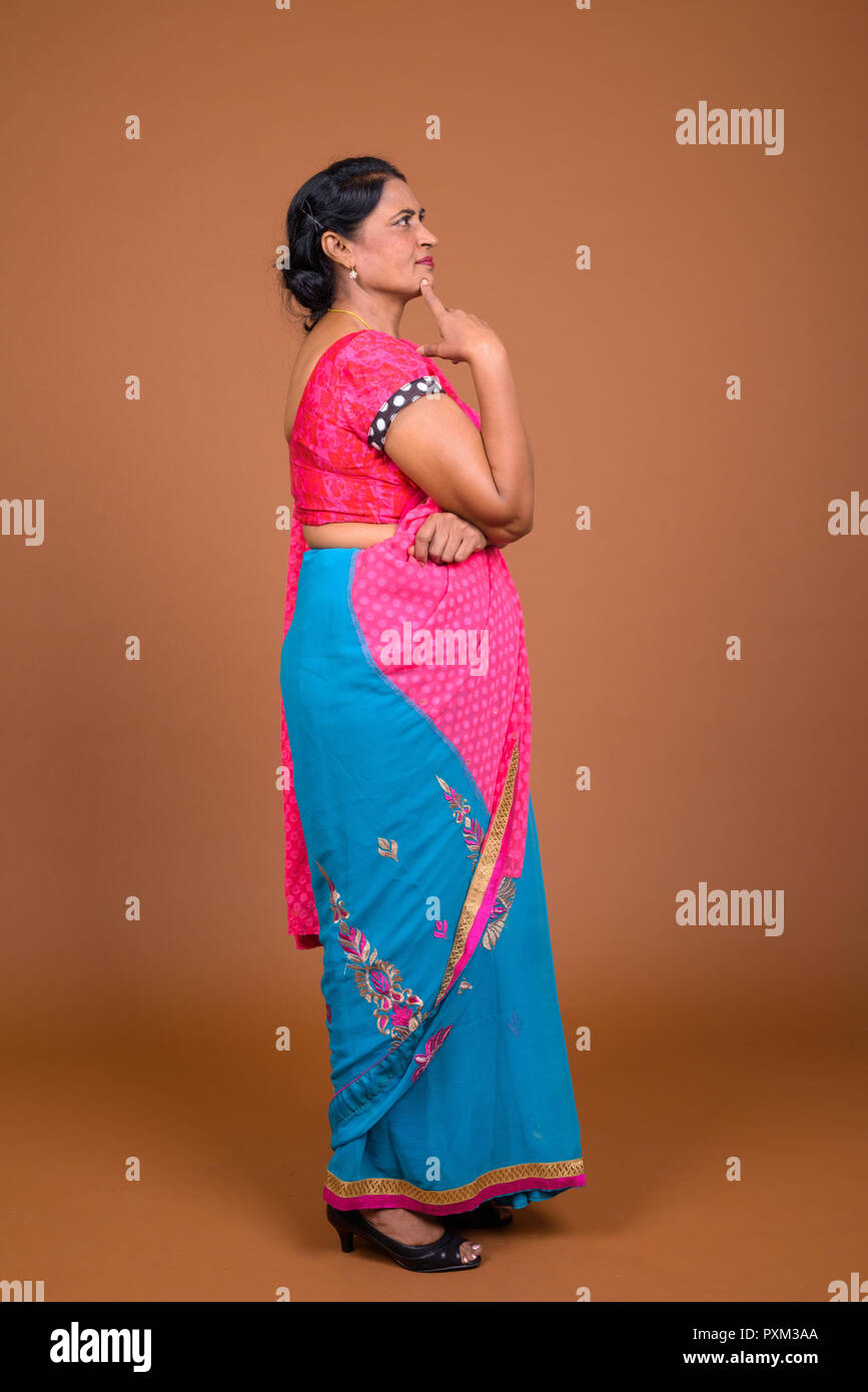 Full length profile view of Indian woman thinking Stock Photo - Alamy