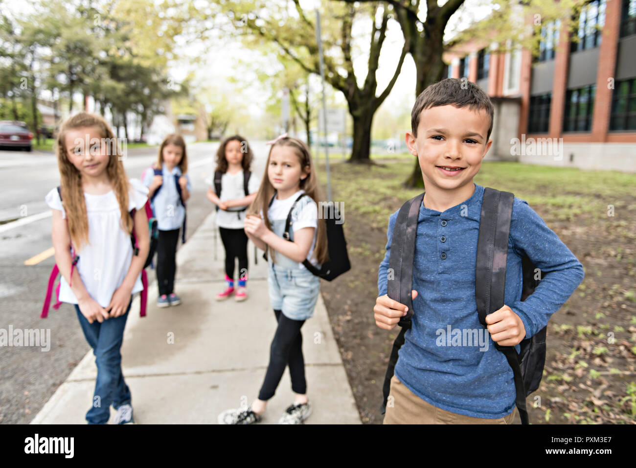 Group of students outside at school standing together Stock Photo - Alamy