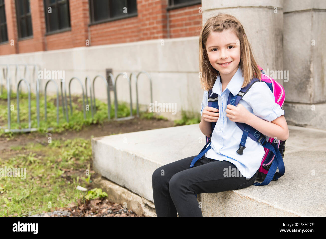 A Portrait of cute girl with backpack outside of school Stock Photo - Alamy