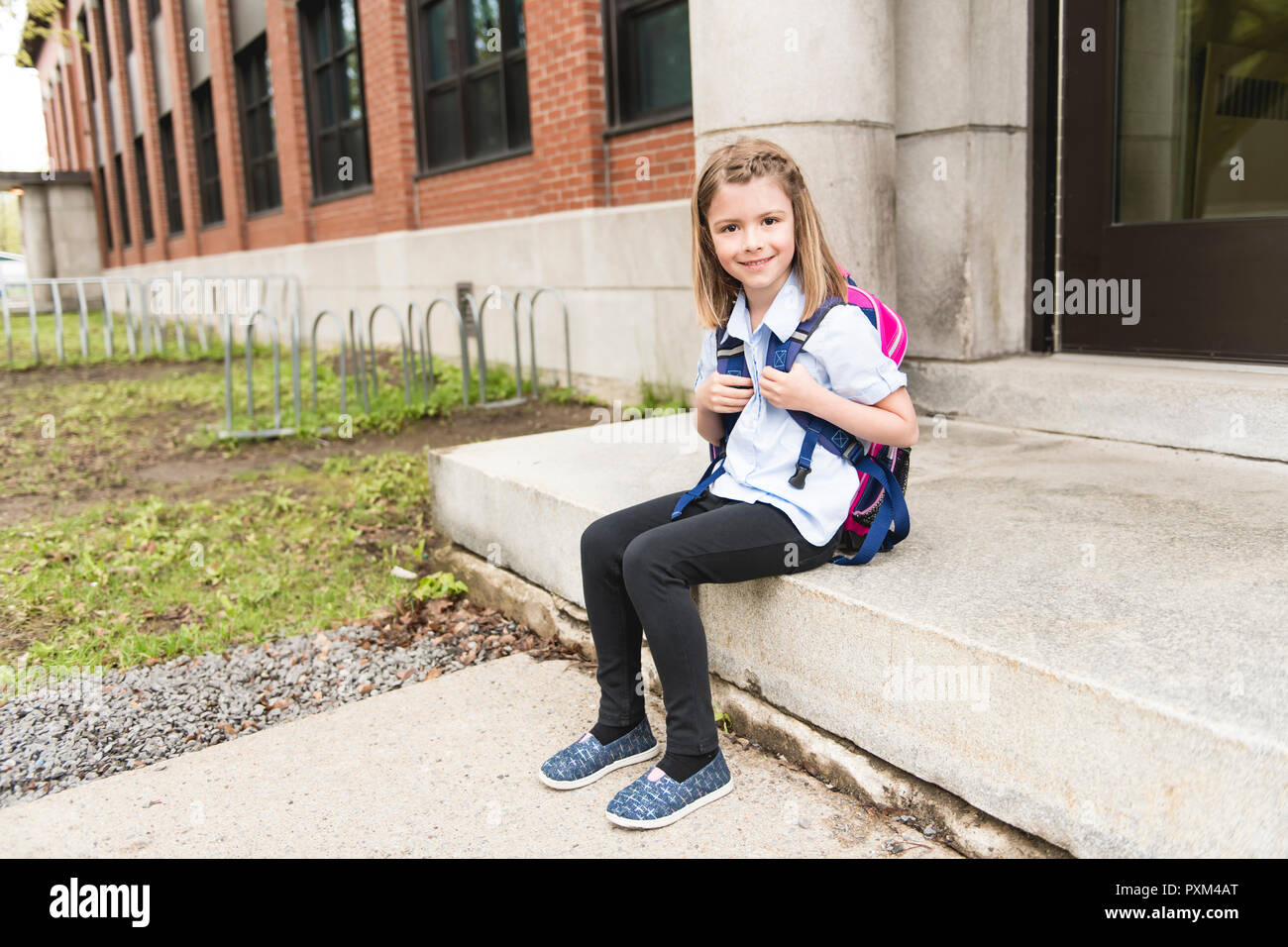 A Portrait of cute girl with backpack outside of school Stock Photo - Alamy
