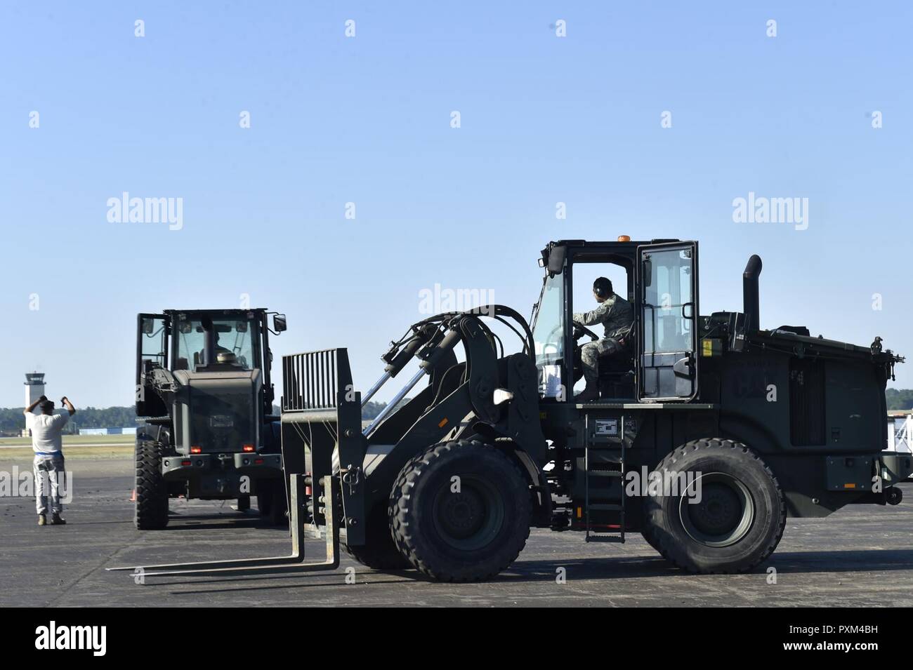 Members from the Joint Task Force-Port Opening element prepare to load ...