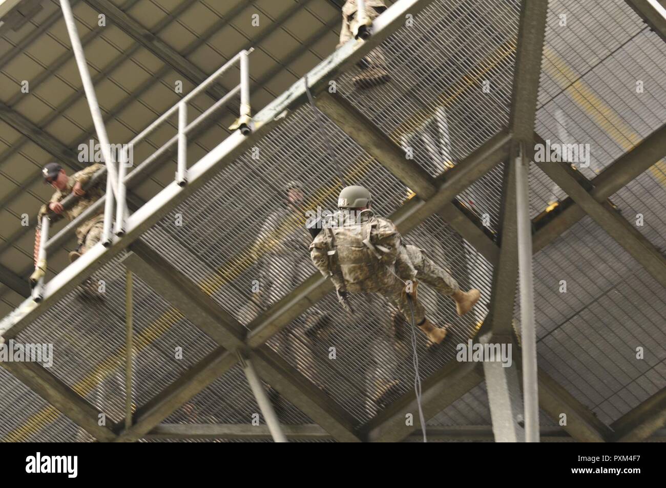 Soldiers and Airmen rappel from a 70-foot tower during the Air Assault ...