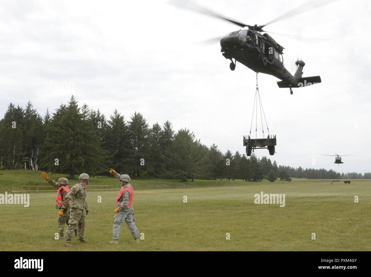 Soldiers signal UH-60 Black Hawk helicopter pilots that it is clear and ...