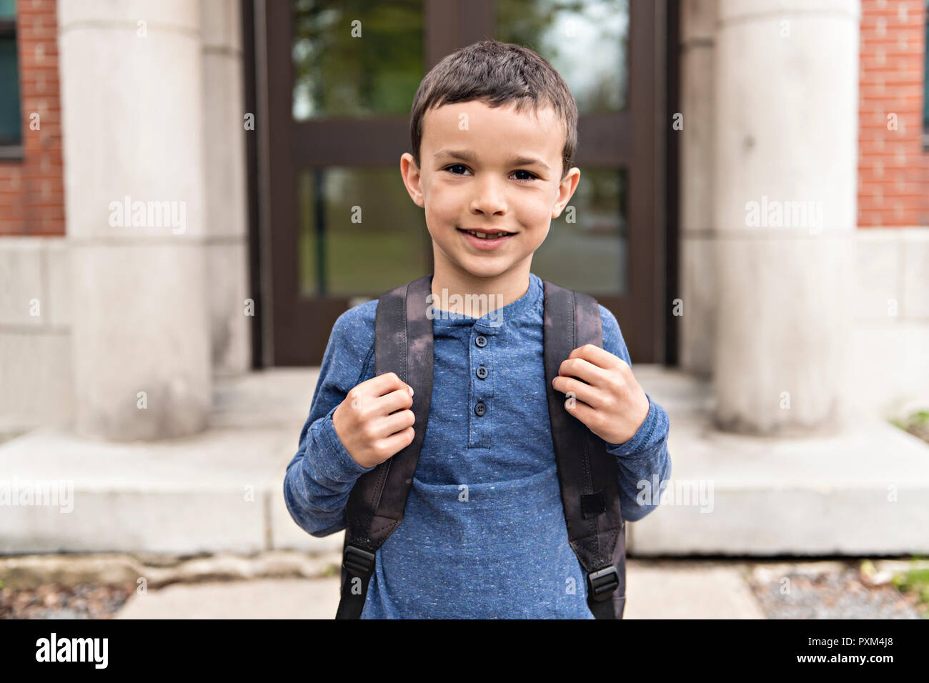 A Portrait of cute boy with backpack outside of school Stock Photo - Alamy