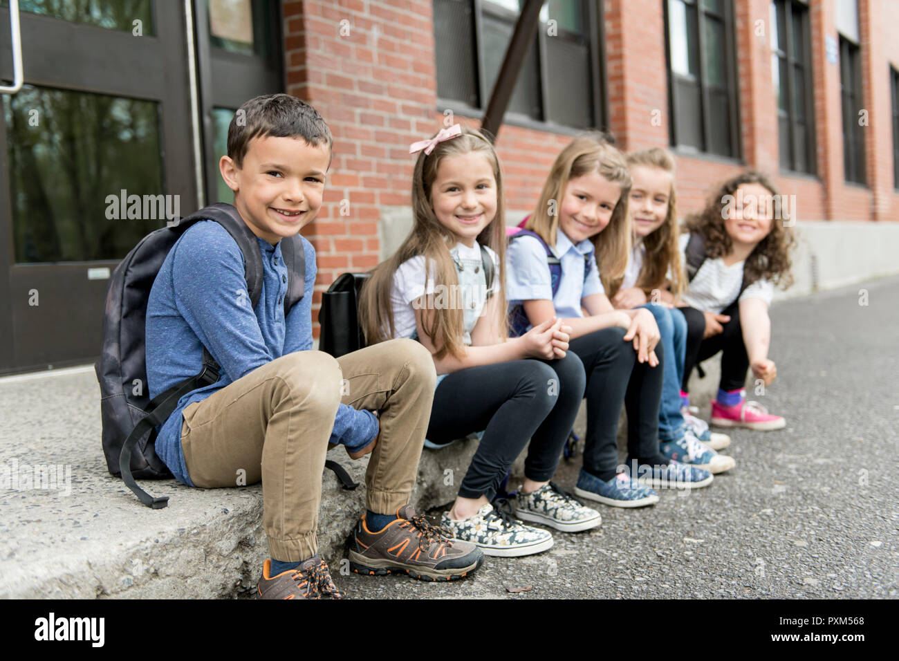 Group of students outside at school standing together Stock Photo - Alamy
