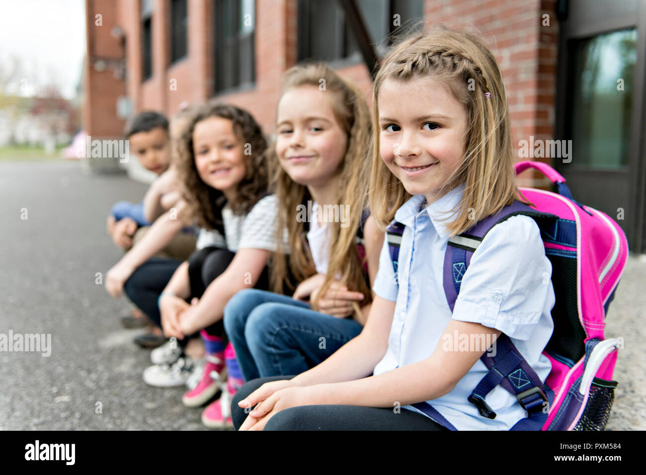 Group of students outside at school standing together Stock Photo - Alamy
