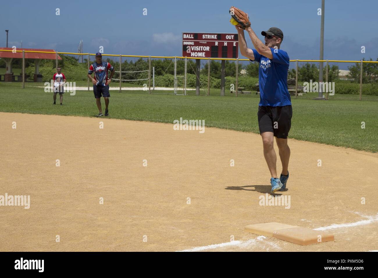 Col. Christopher Feyedelem catches a ball at first base during a ...