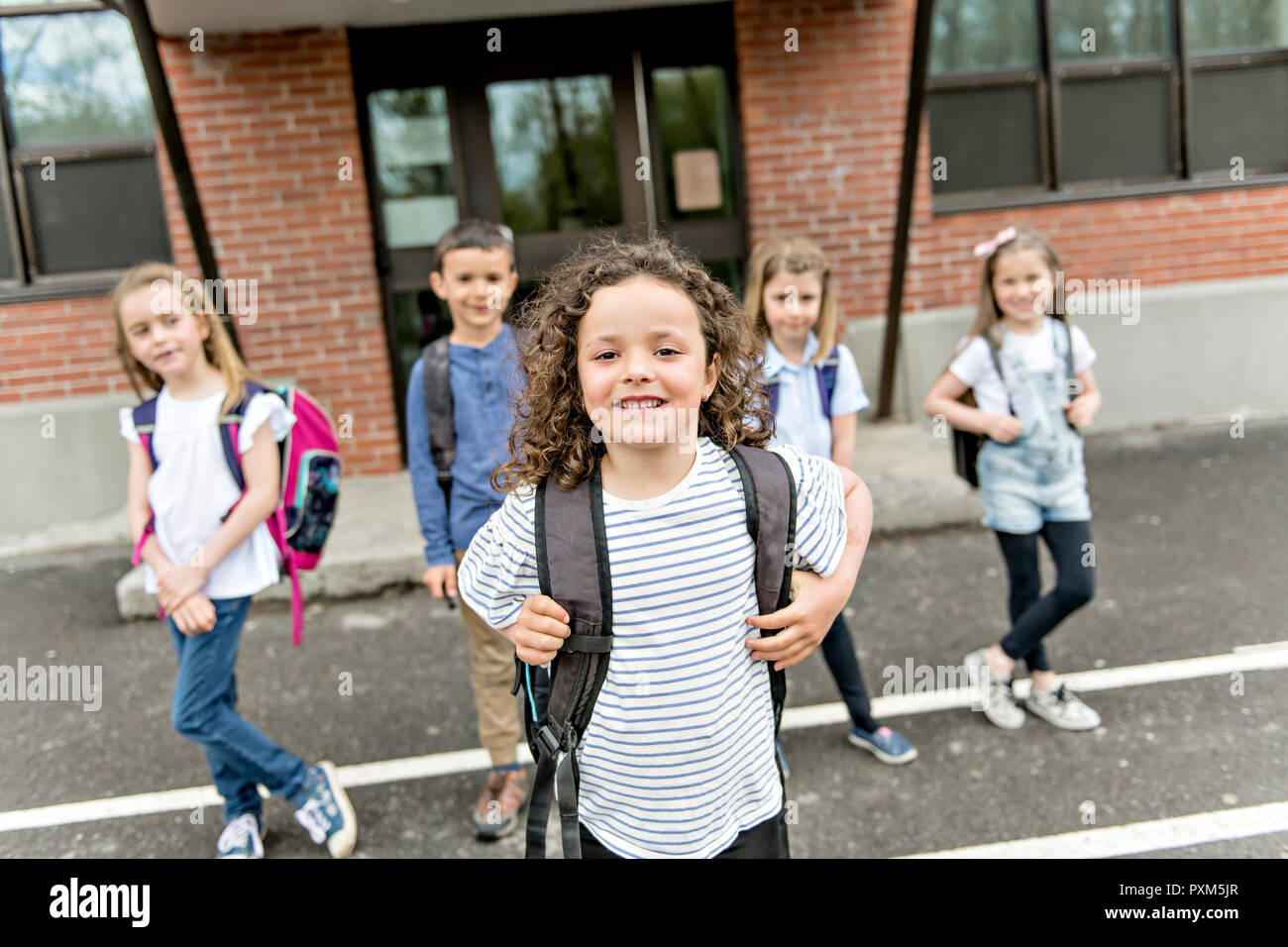 Four students outside school standing hi-res stock photography and ...