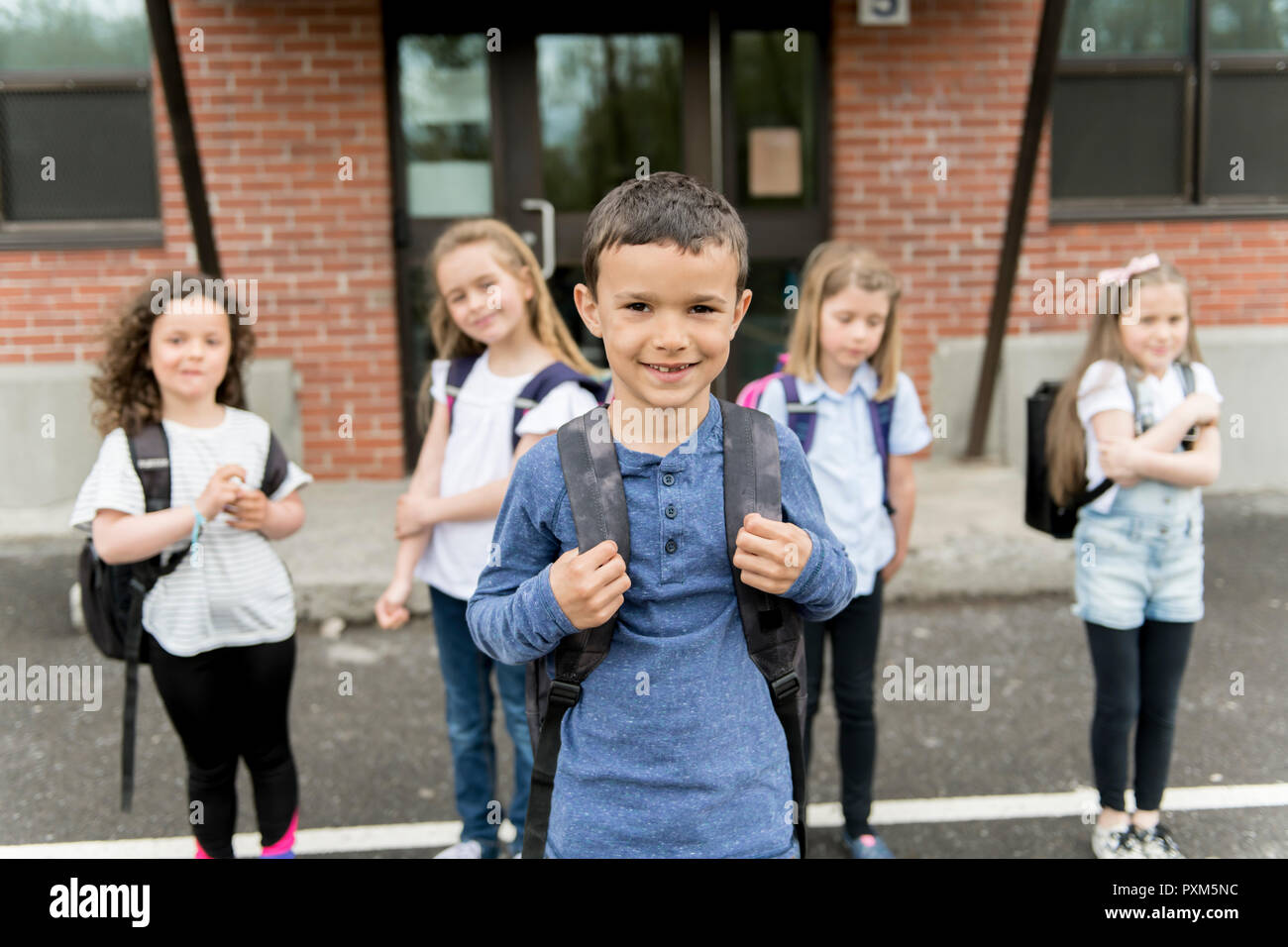 Group of students outside at school standing together Stock Photo - Alamy