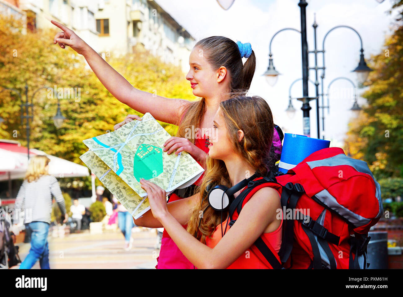 Traveller girls with backpack looking for way tourist paper map Stock ...