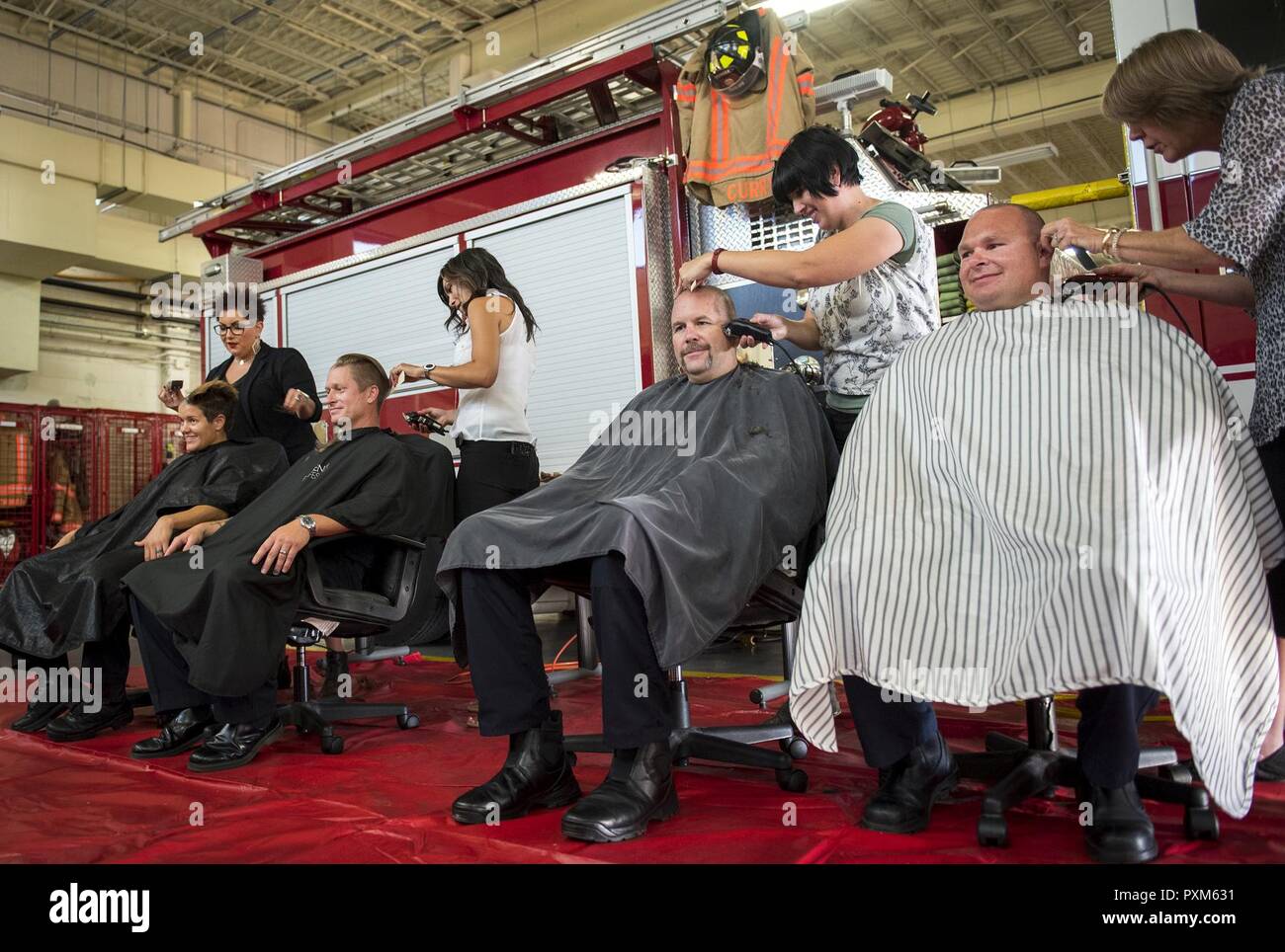 A group of firefighters receive a very close shave June 8 at Eglin Air ...