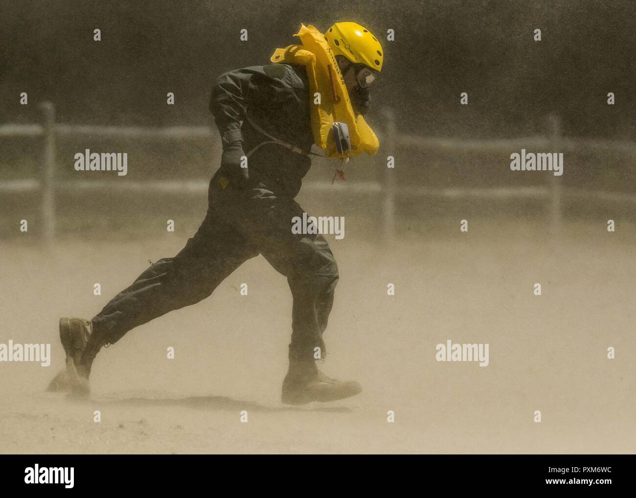 Lt. Col. Brandon Dow, 54th Airlift Squadron, runs through the dust ...