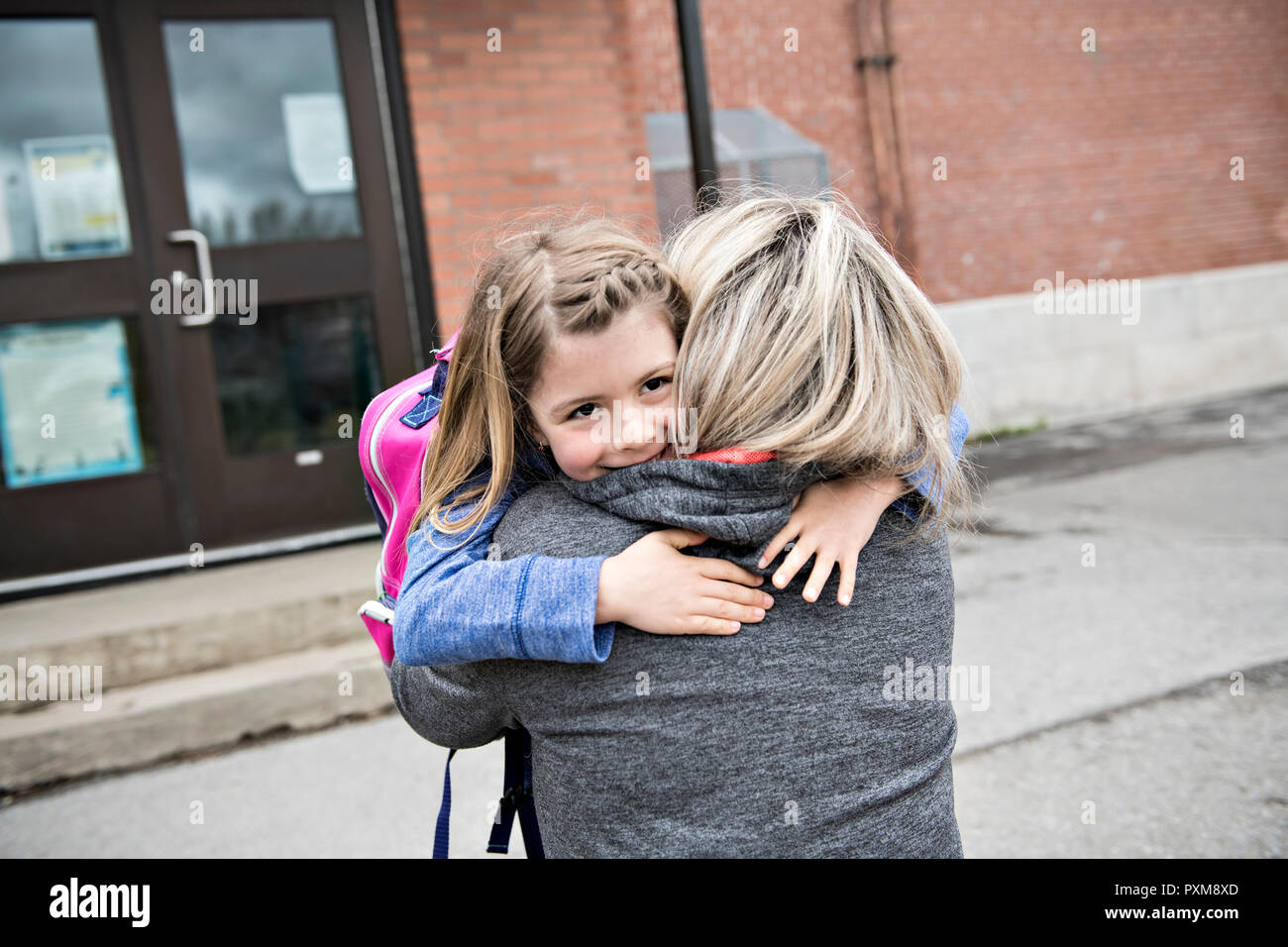 Female teacher hugging children hi-res stock photography and images - Alamy