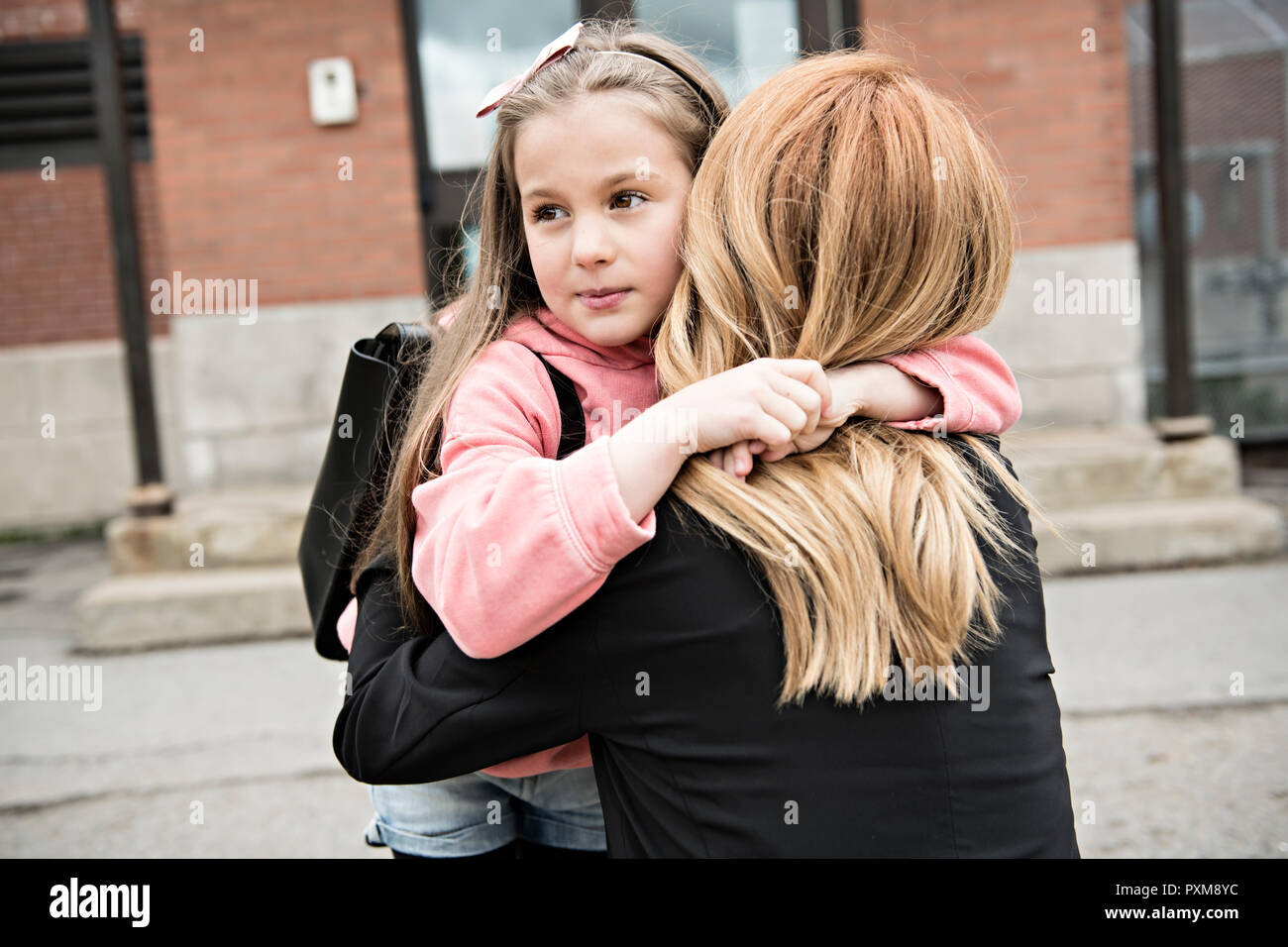Female teacher hugging children hi-res stock photography and images - Alamy