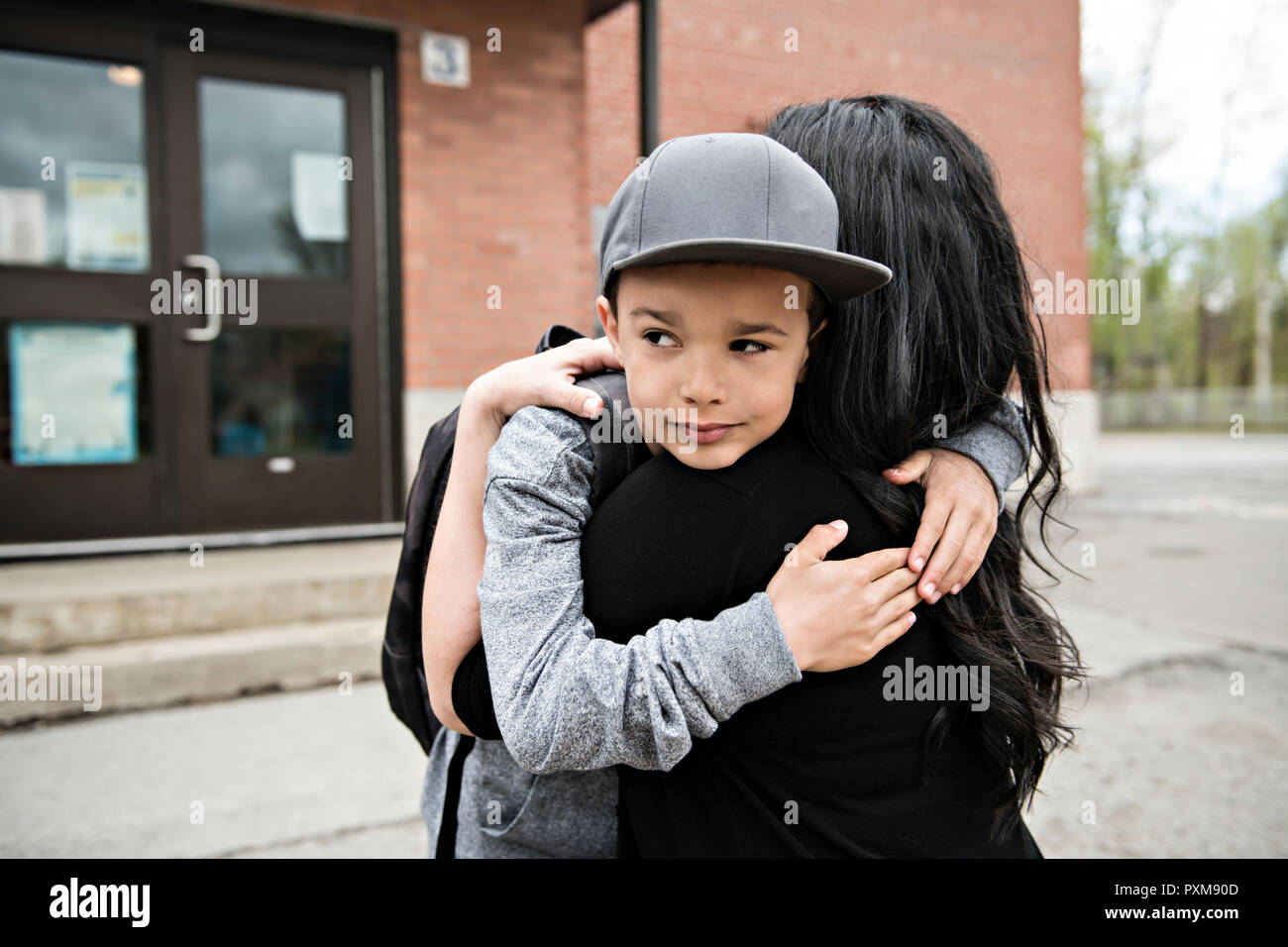 A Boy and his mother hugging outside at school Stock Photo - Alamy