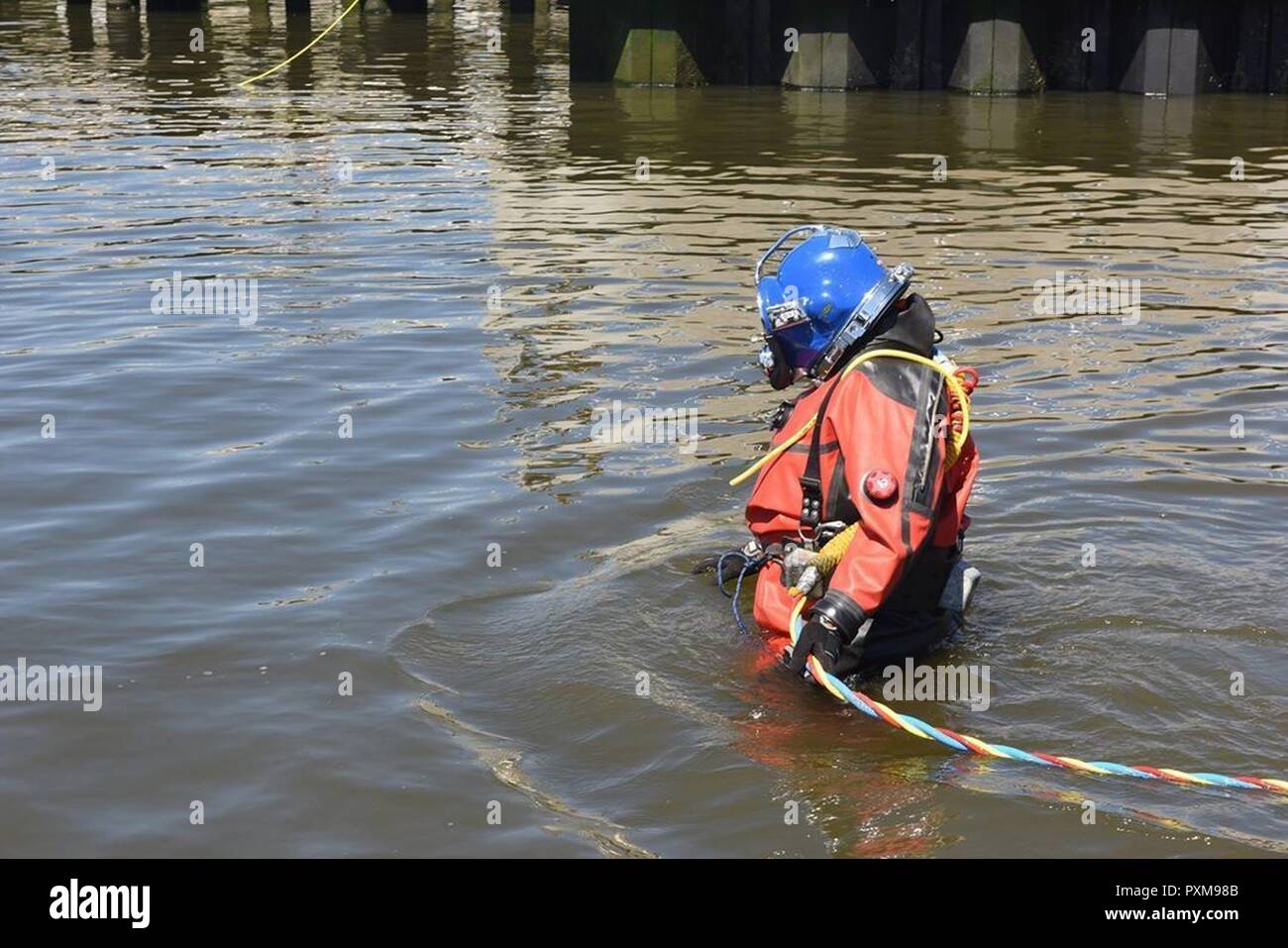 A diver walks into the water during a community project called Warriors ...