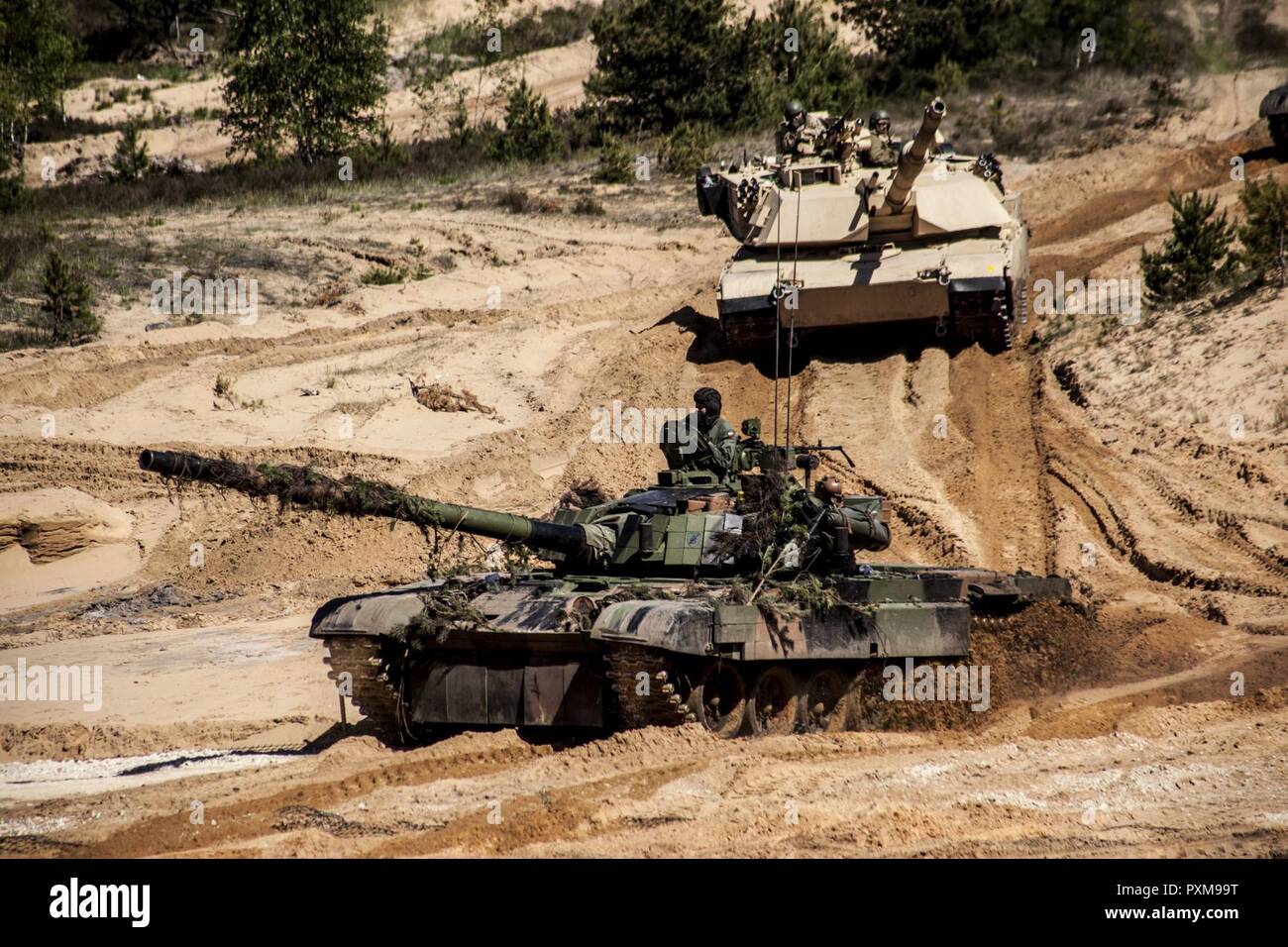 ADAZI, Latvia-- Polish soldiers operate PT-91 Twardy tanks alongside U ...
