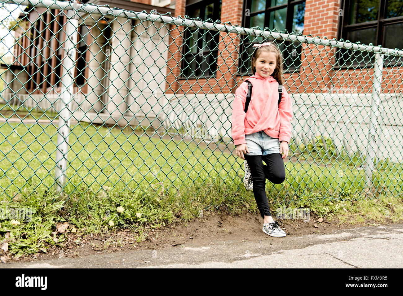 A Portrait of cute girl with backpack outside of school Stock Photo - Alamy
