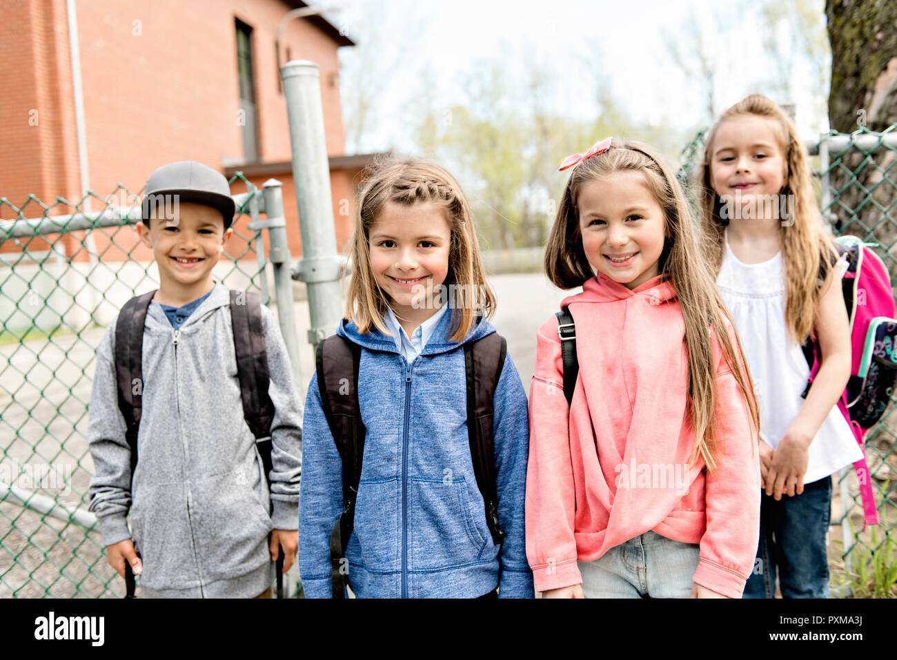 Group of students outside at school standing together Stock Photo - Alamy