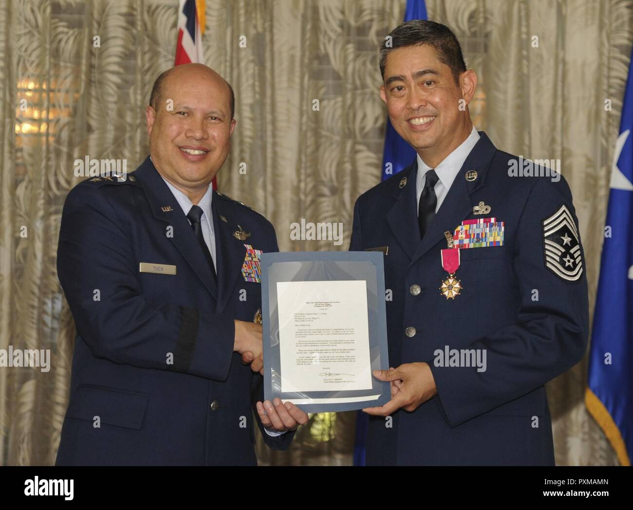 Lt. Gen. Giovanni Tuck, Eighteenth Air Force commander, presents a ...