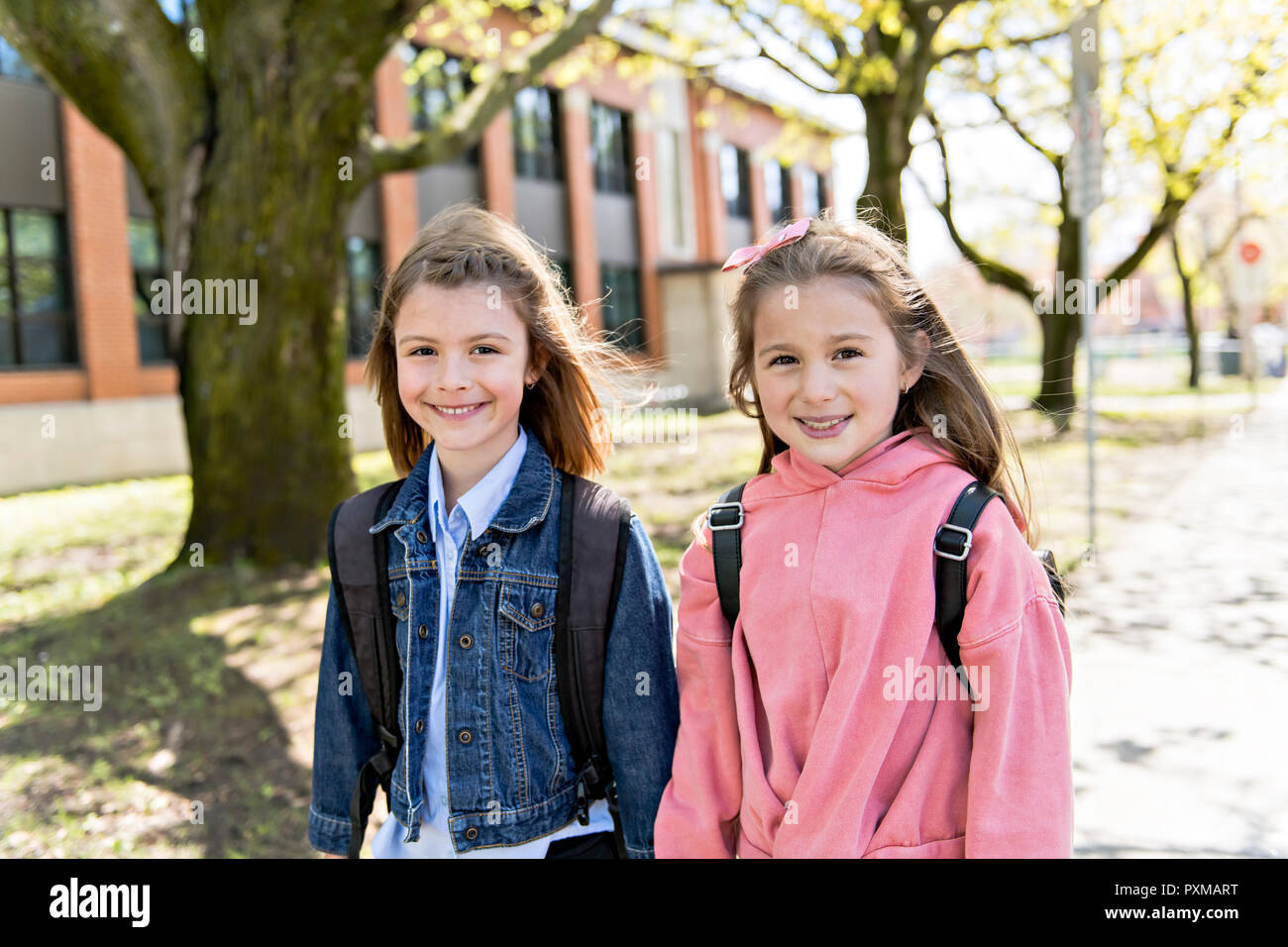 A group of Two students outside at school standing together Stock Photo ...