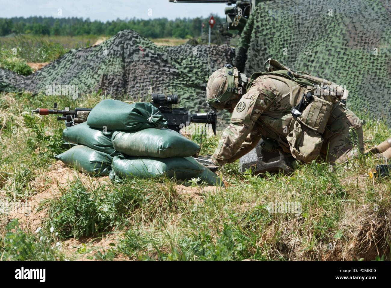 Battle Group Poland U.S. Soldiers improve their fire positions near the ...