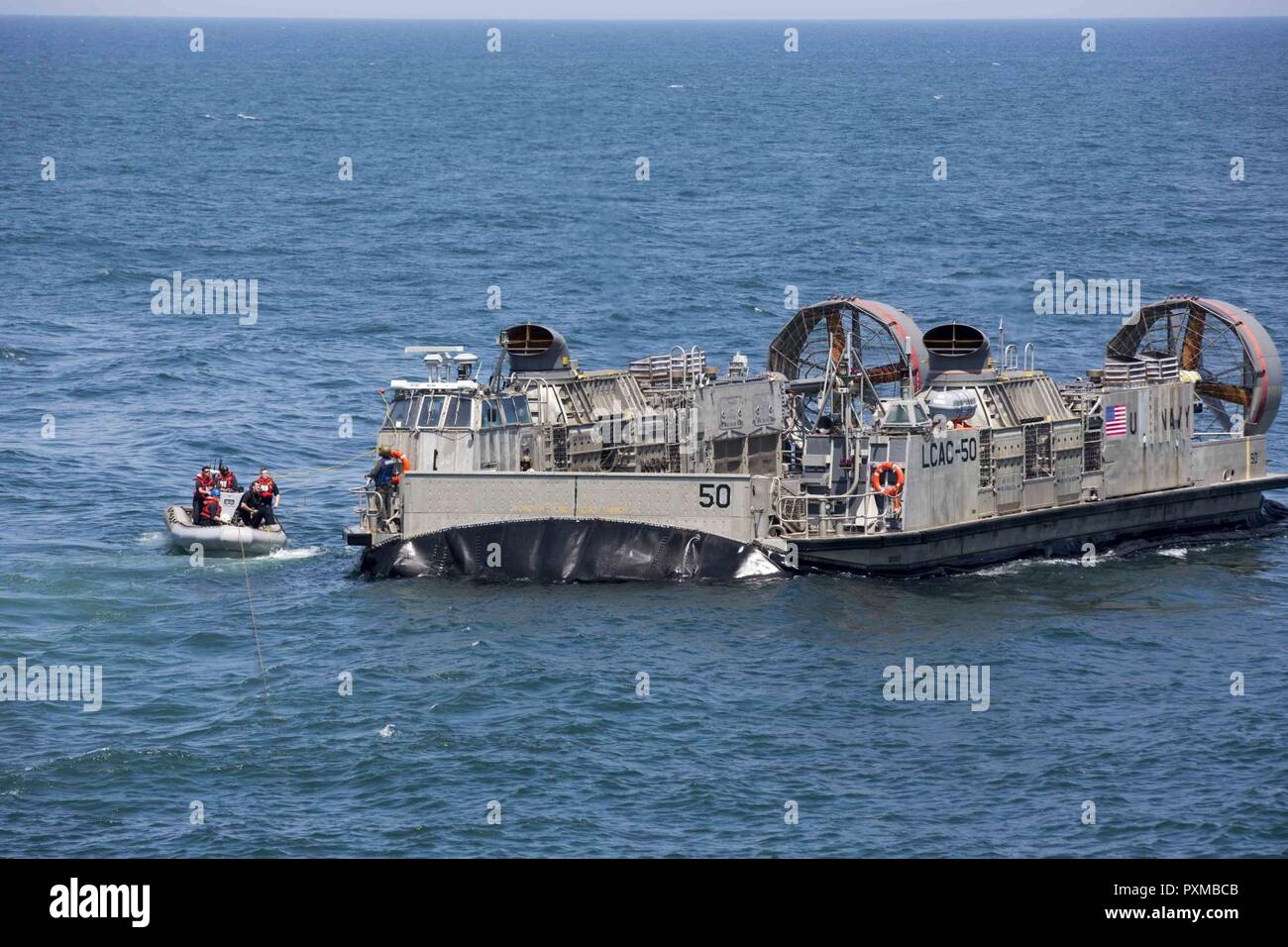 ATLANTIC OCEAN (June 13, 2017) Sailors pass a messenger line to a ...