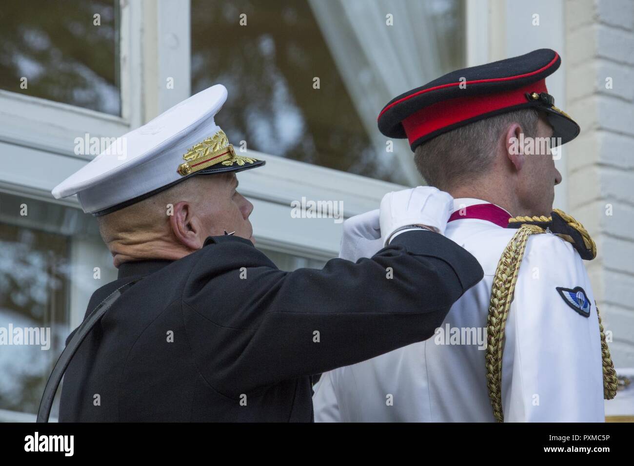 Commandant of the Marine Corps Gen. Robert B. Neller, left, presents a ...