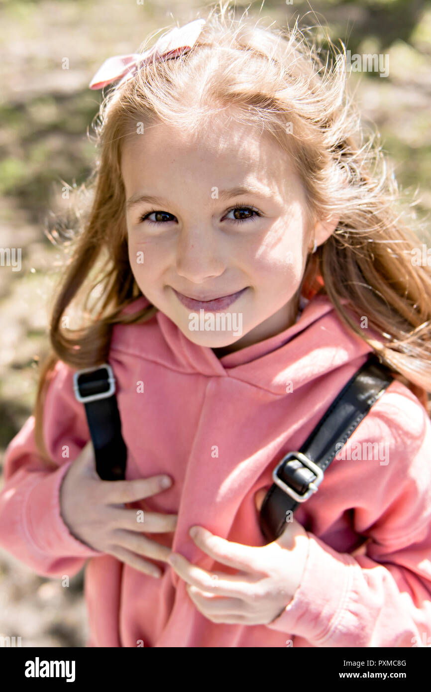A Portrait of cute girl with backpack outside of school Stock Photo - Alamy