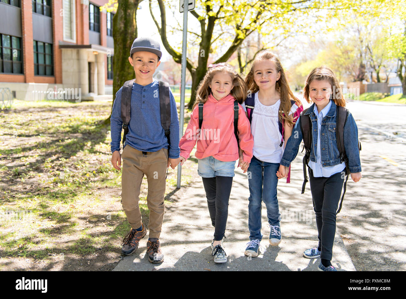 Group of students outside at school standing together Stock Photo - Alamy