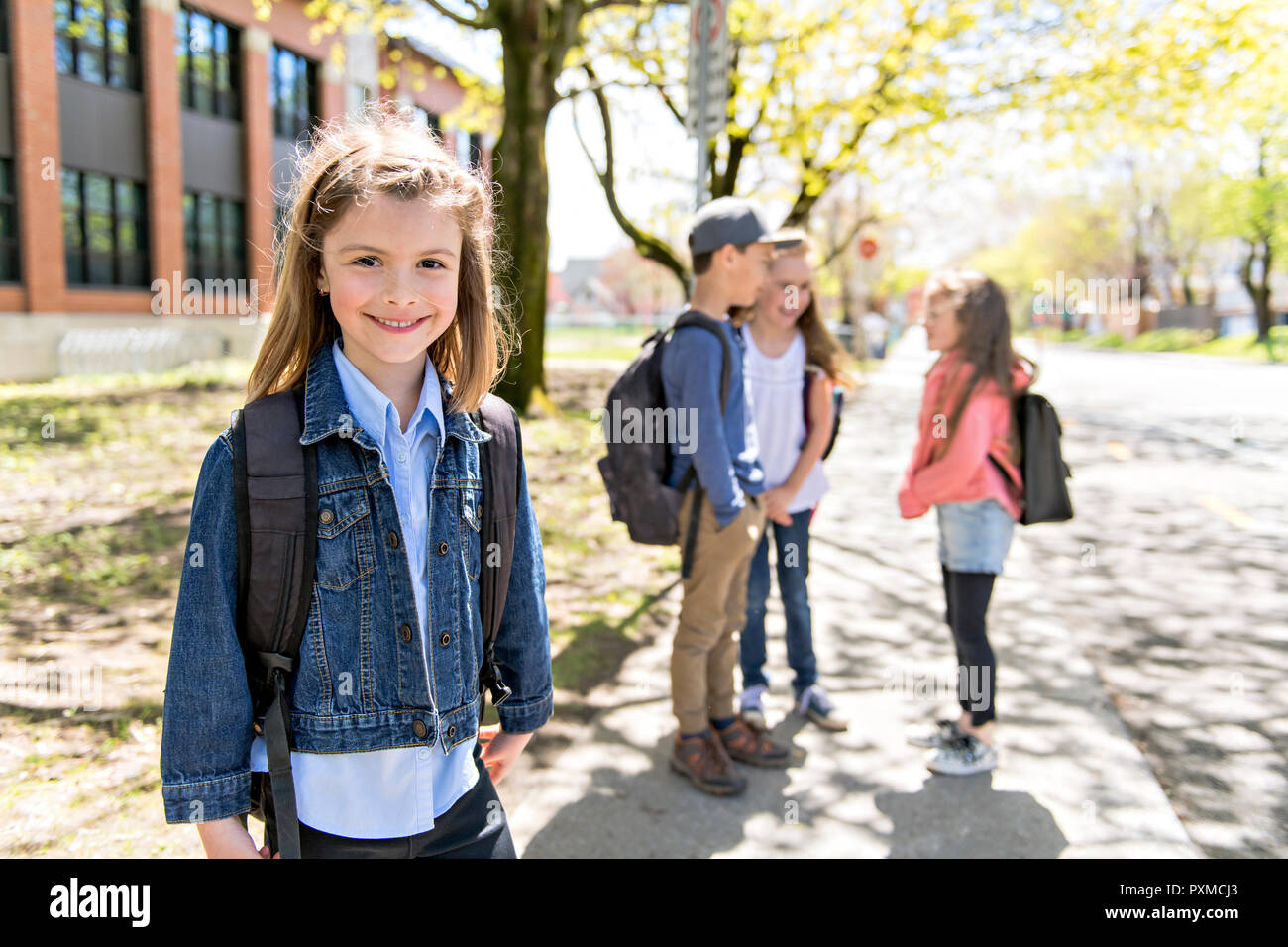 Group of students outside at school standing together Stock Photo - Alamy