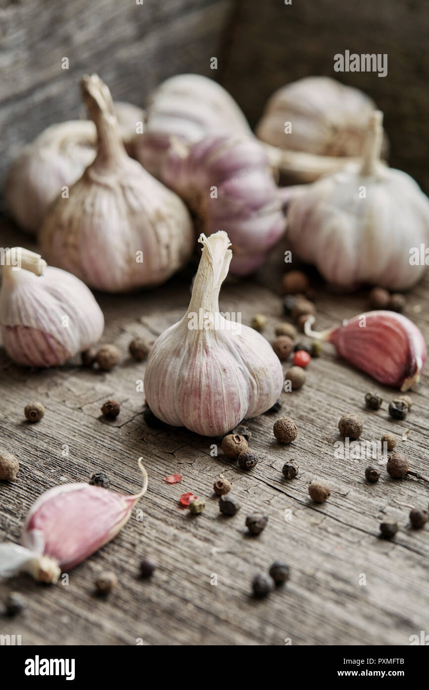 Garlic with fragrant pepper on a gray background Stock Photo - Alamy