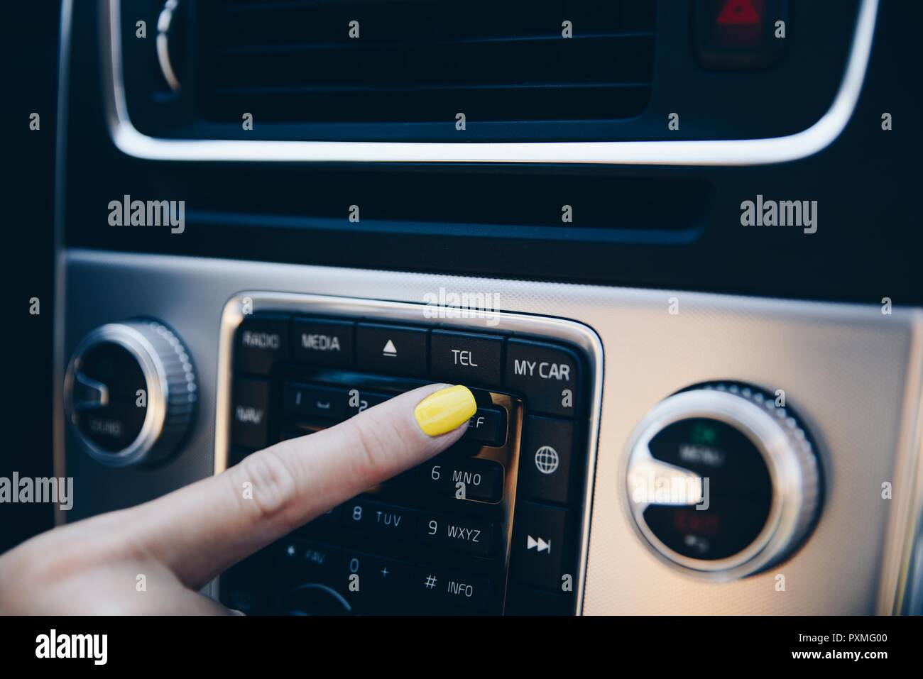 Woman turning on car phone. Modern car interior Stock Photo - Alamy